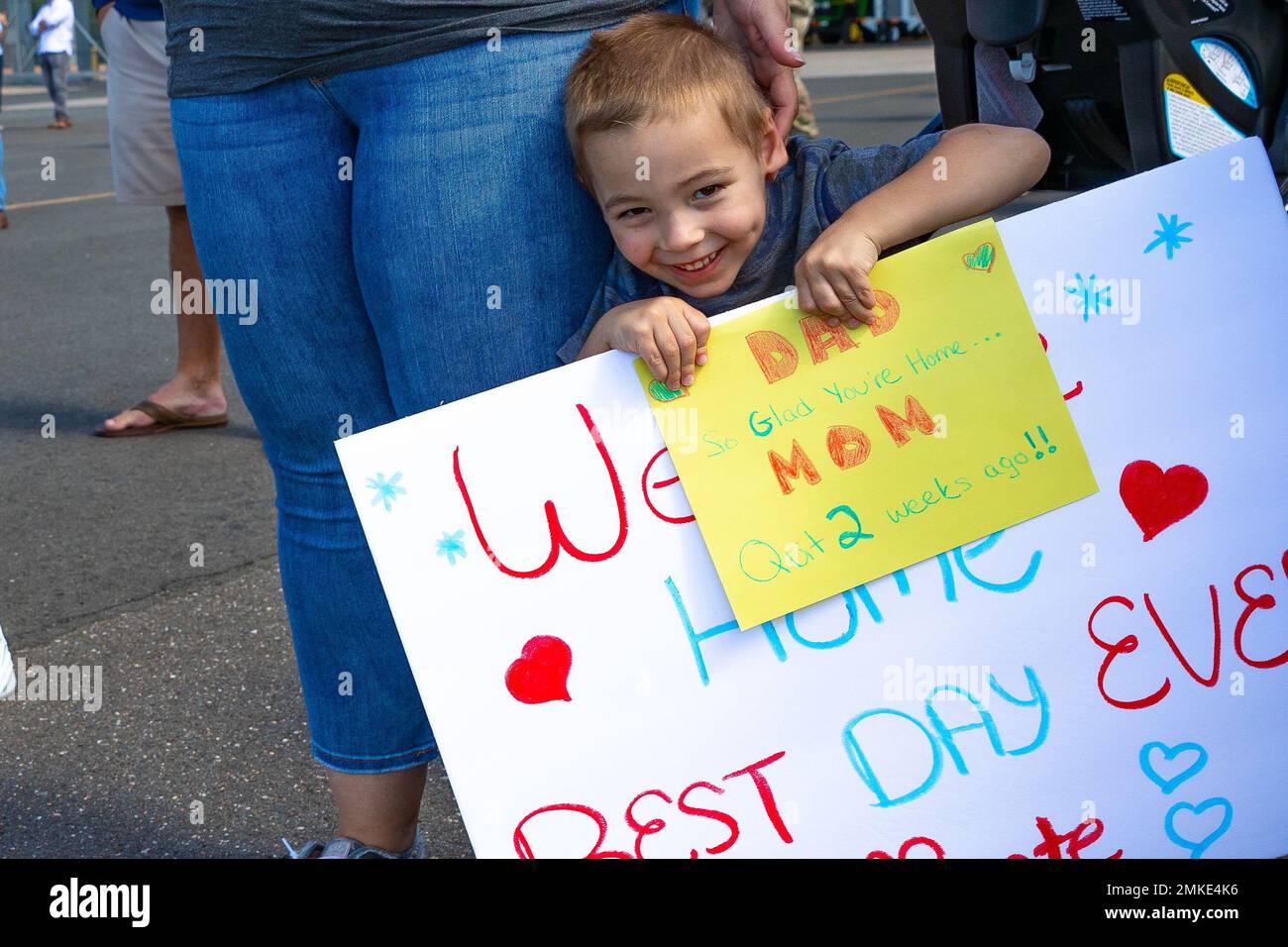 The son of a 142nd Area Support Medical Company soldier holds up a ...