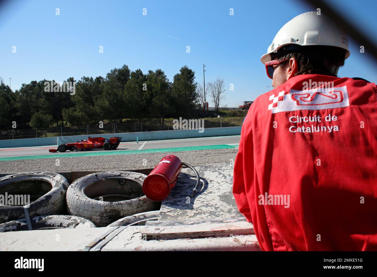 A track marshal watches as Ferrari driver Charles Leclerc of Monaco drives by during a Formula ...