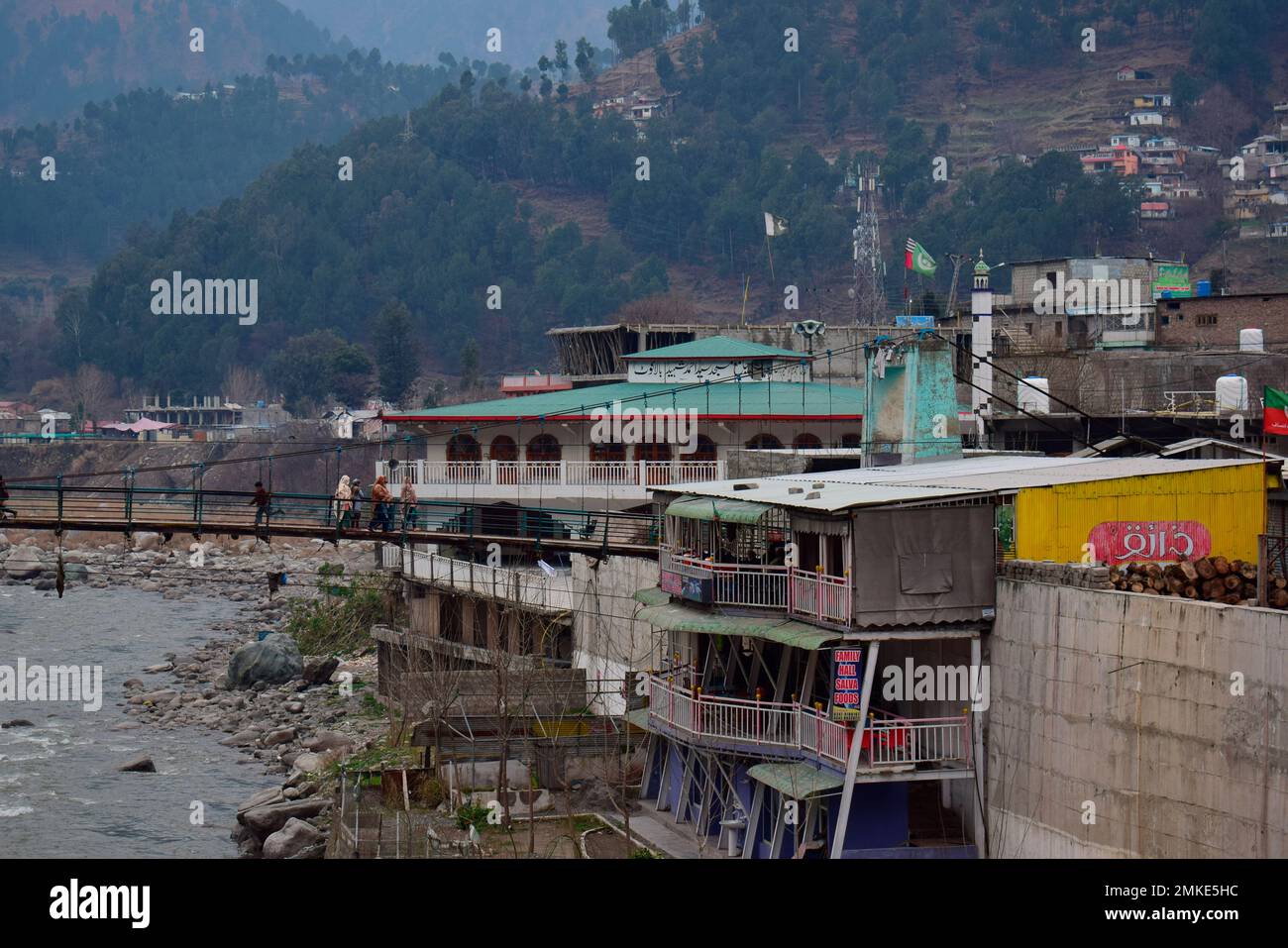 Pakistan villagers cross a bridge in Balakot, Pakistan, Tuesday, Feb ...