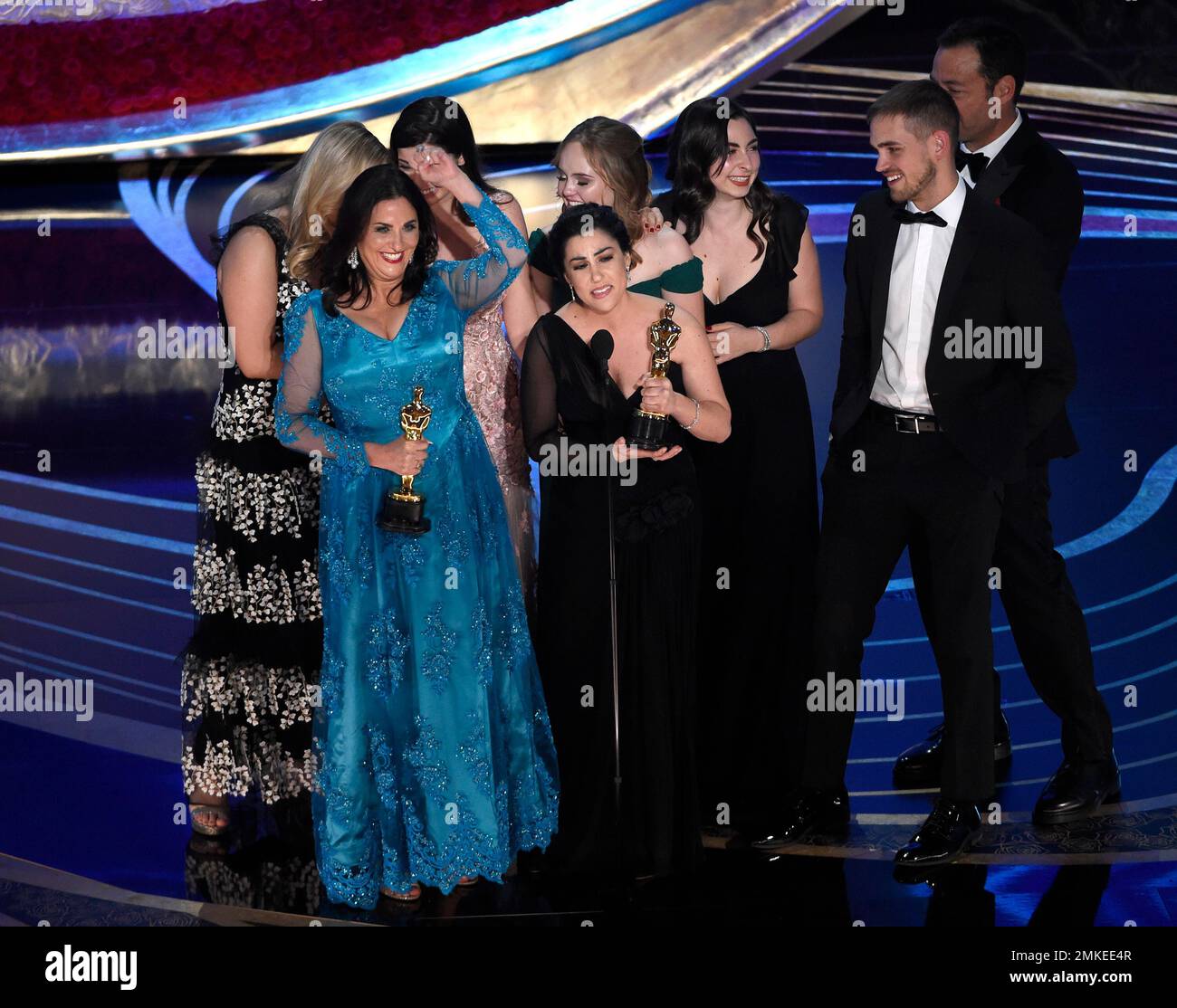 Melissa Berton, center left, and Rayka Zehtabchi accept the award for ...