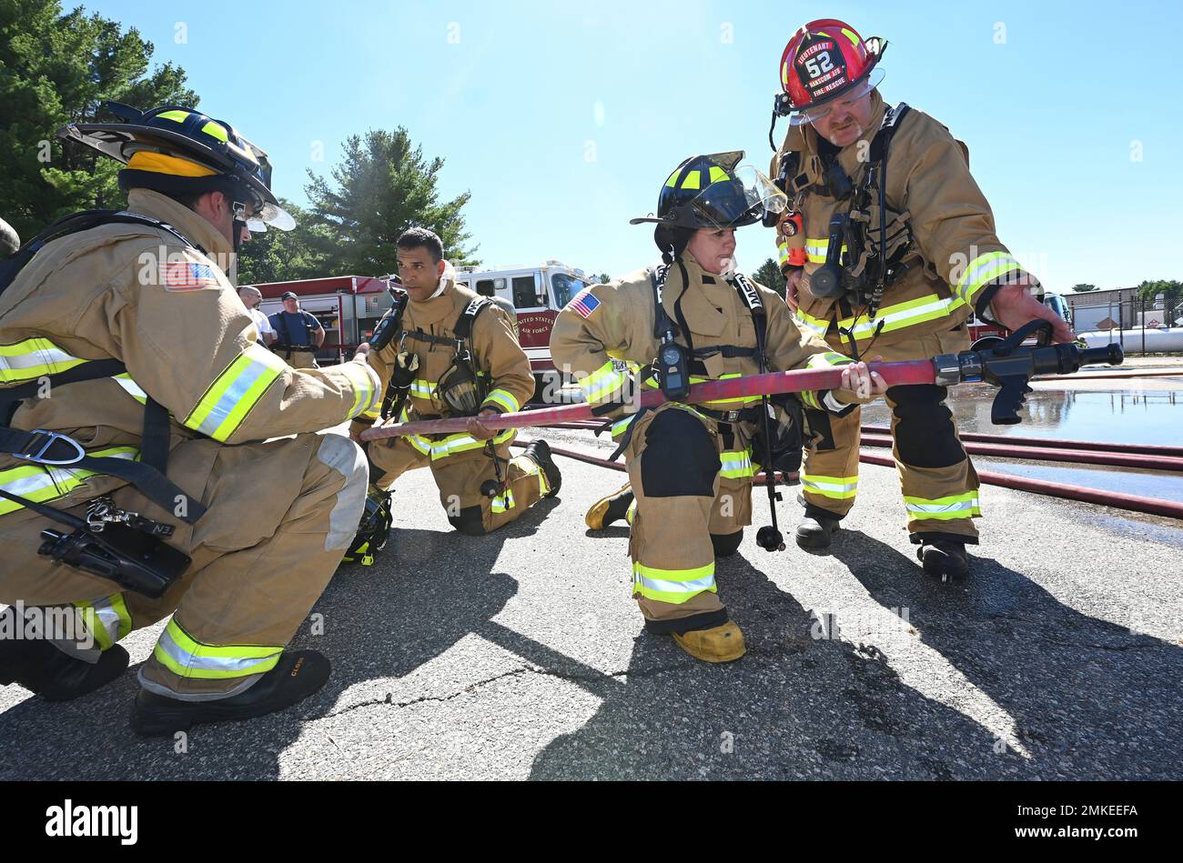 Fire Lt. Keith Williams, right, instructs Col. Taona Enriquez ...