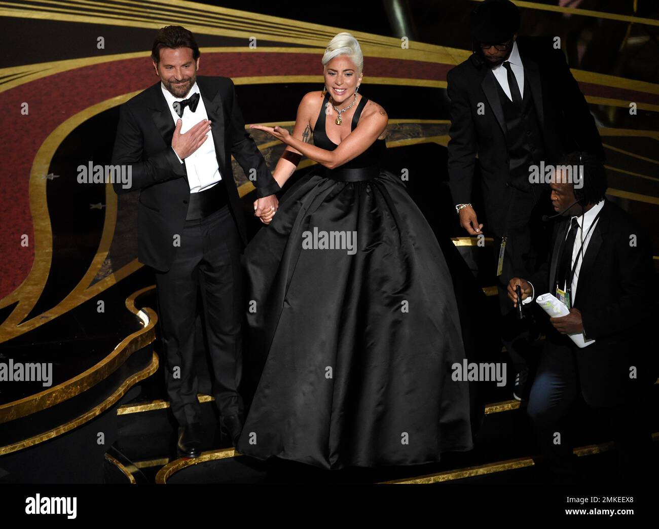 Bradley Cooper, left, and Lady Gaga react to the audience after a ...