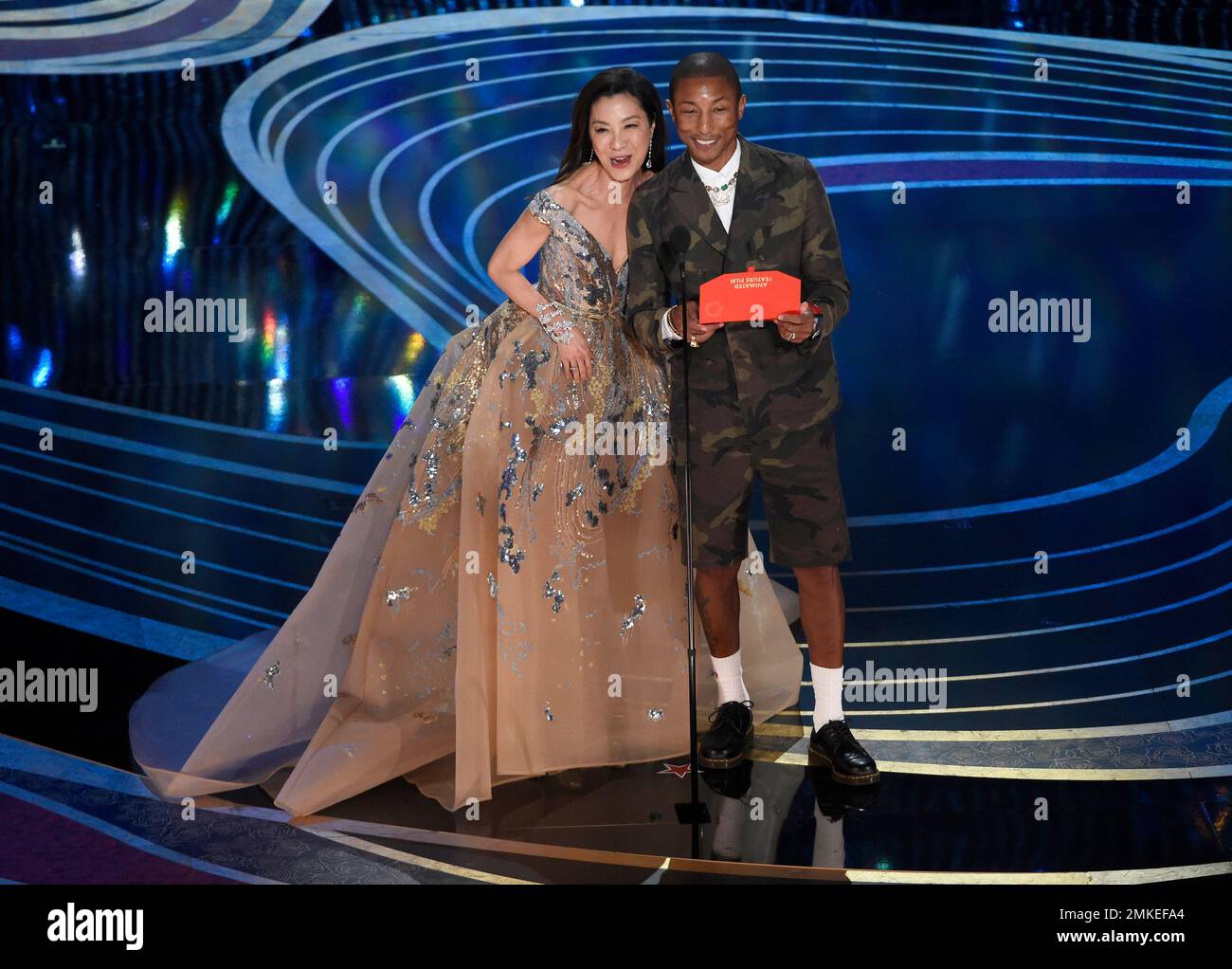 Michelle Yeoh, left, and Pharrell Williams present the award for best ...