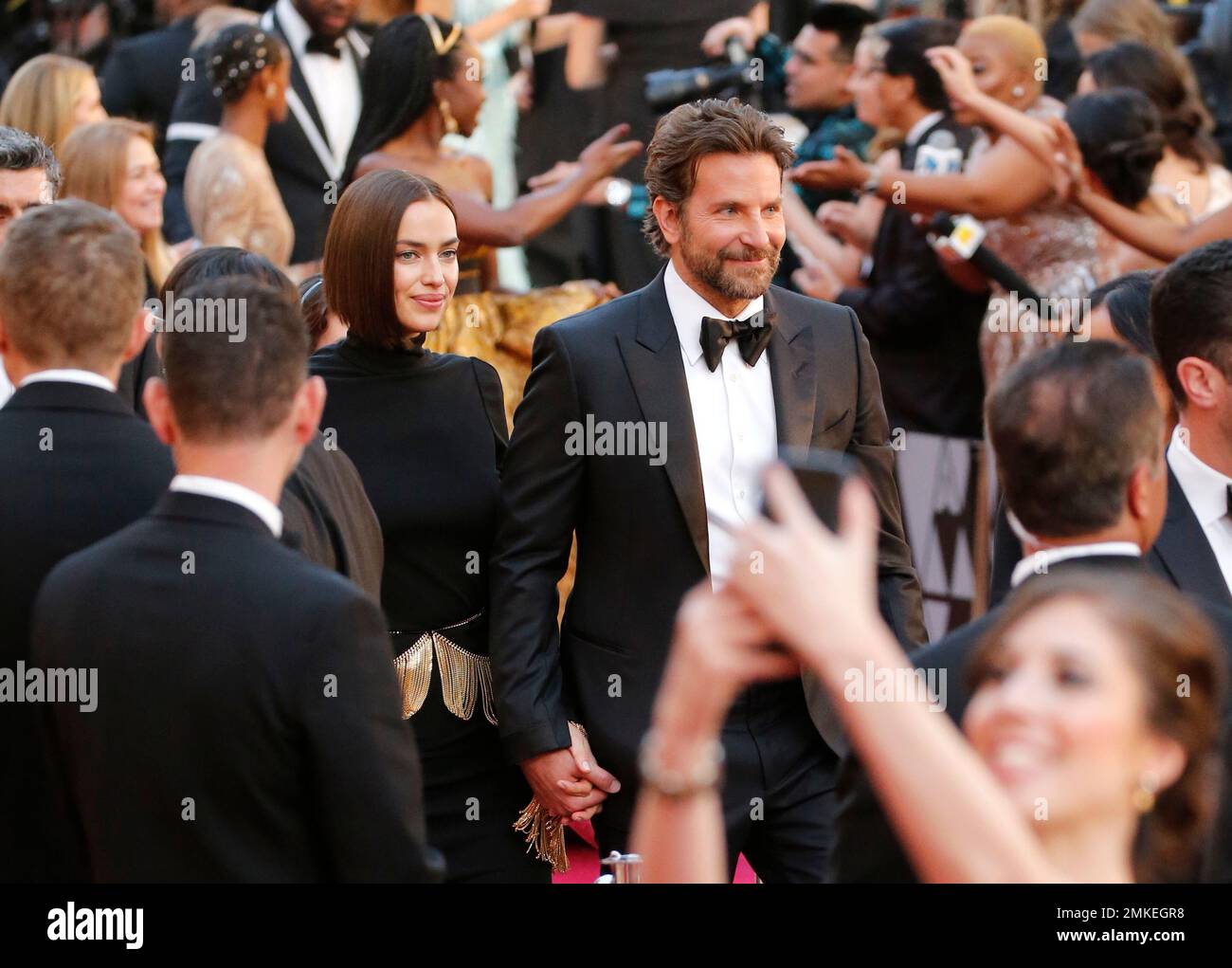 Bradley Cooper, right, and Irina Shayk arrive at the Oscars on Sunday ...