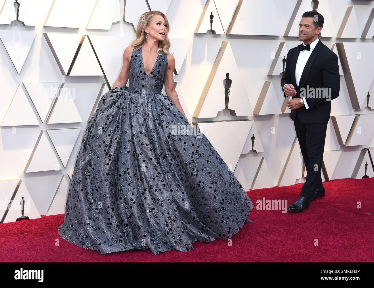 Kelly Ripa, left, and Mark Consuelos arrive at the Oscars on Sunday ...