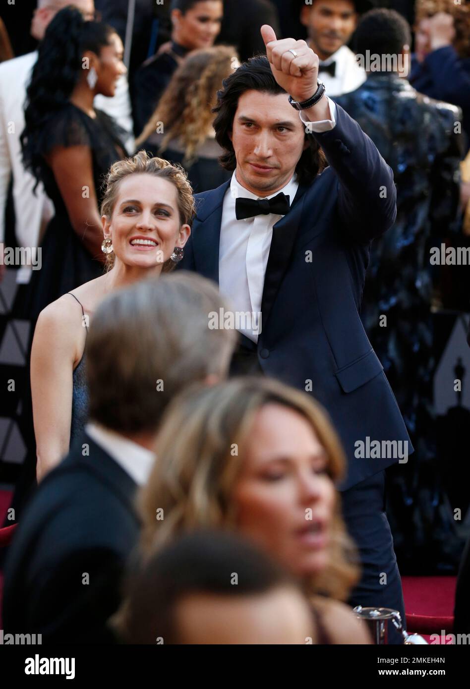 Joanne Tucker, left, and Adam Driver arrive at the Oscars on Sunday ...