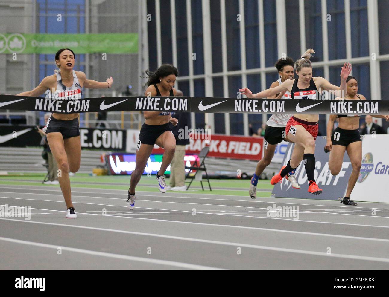 Shania Collins, left, crosses the finish line first during the women's ...