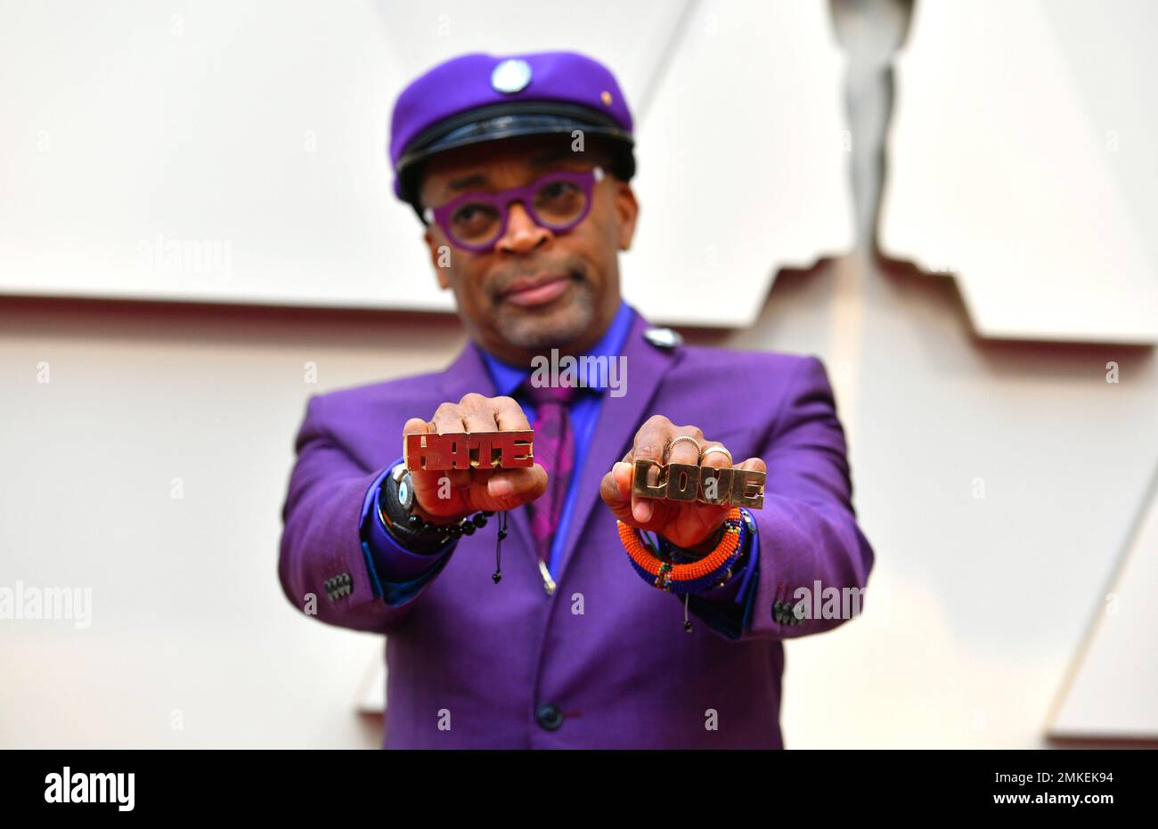 Spike Lee holds up brass knuckles reading "hate" and "love" from his ...