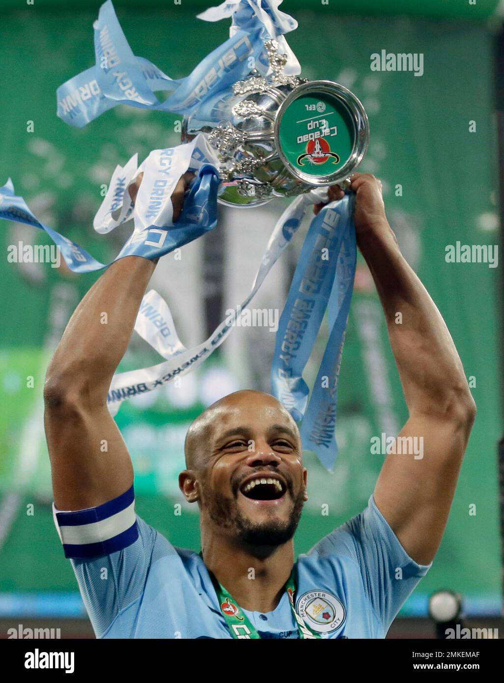 Manchester City's Vincent Kompany lifts the trophy after winning the ...