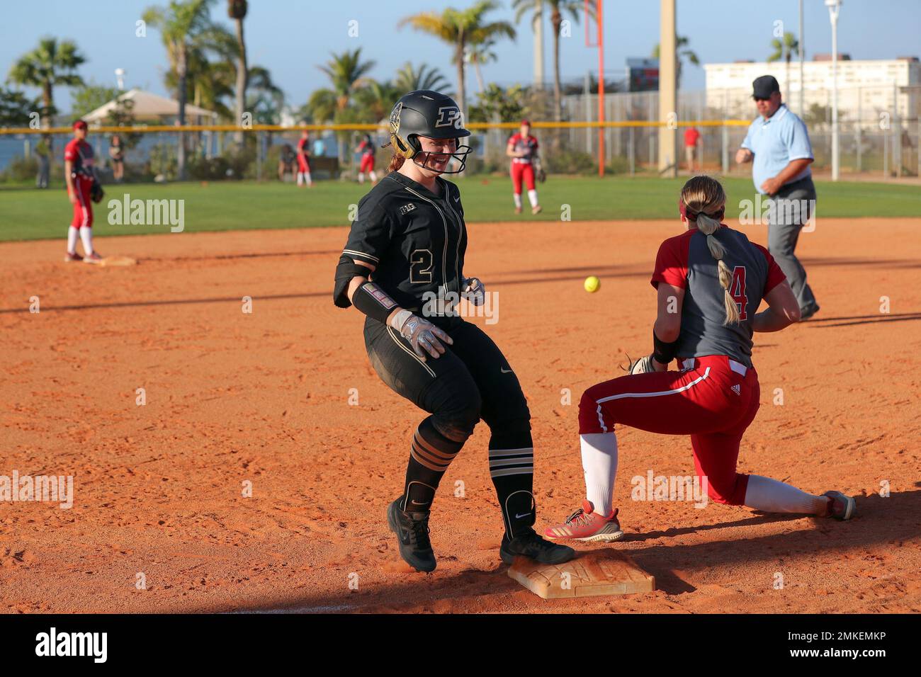 Mallory Baker of Purdue arrives safely to third base as Dustie Durham ...