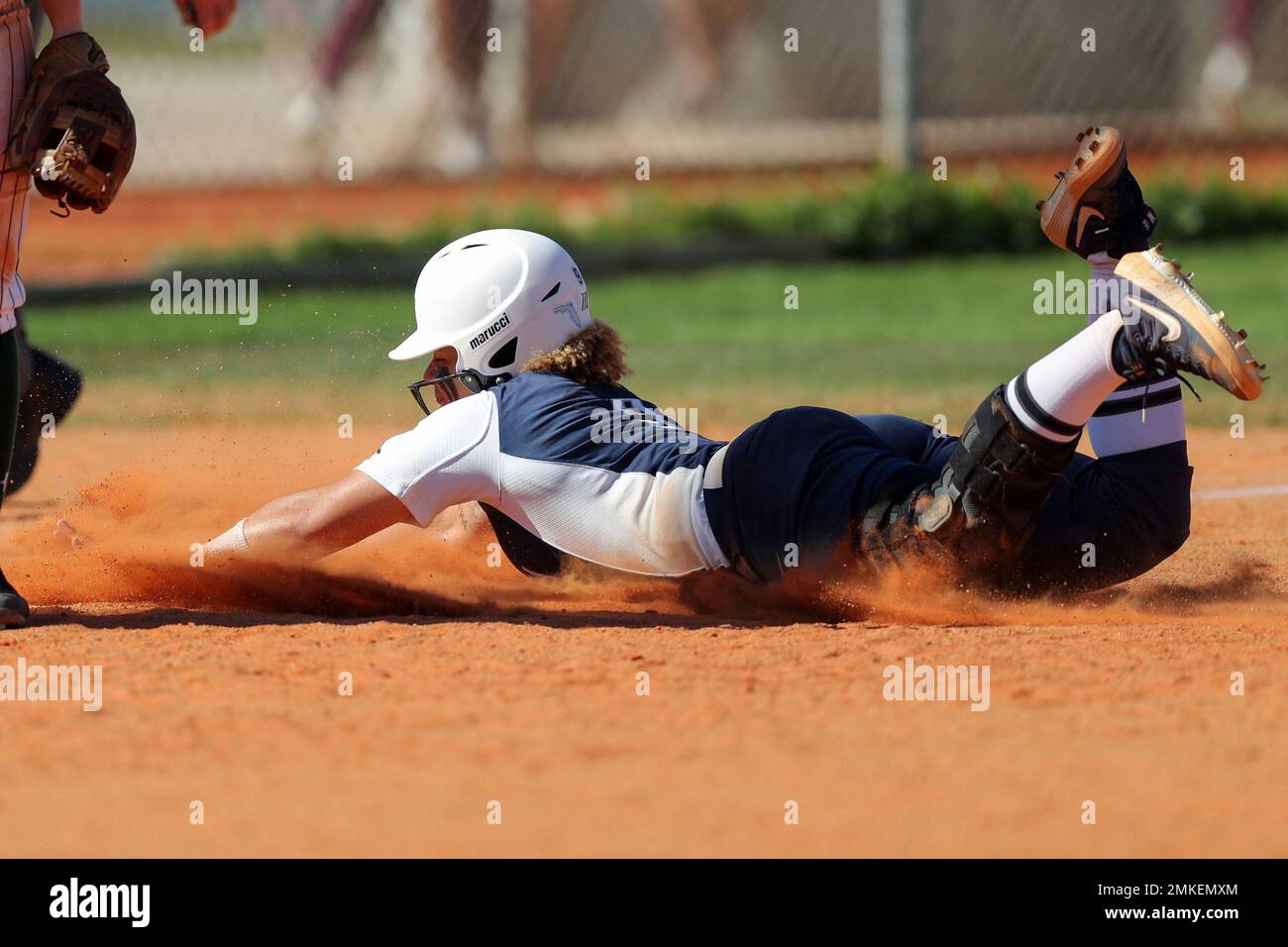 Navia Penrod of North Florida slides into third base against Manhattan ...