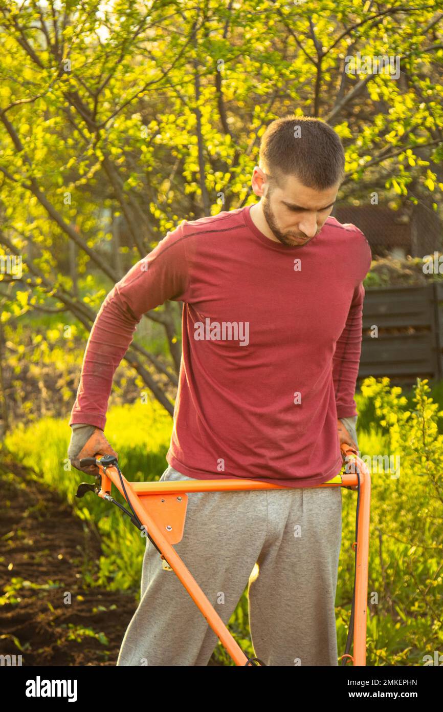 Man on tractor plowing garden hi-res stock photography and images - Alamy