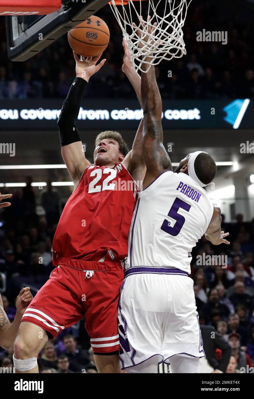 Wisconsin forward Ethan Happ, left, shoots against Northwestern center ...