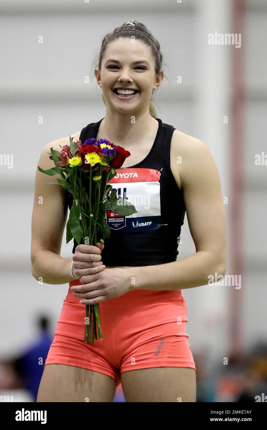 Kate Hall poses for photographers after winning the women's long jump ...