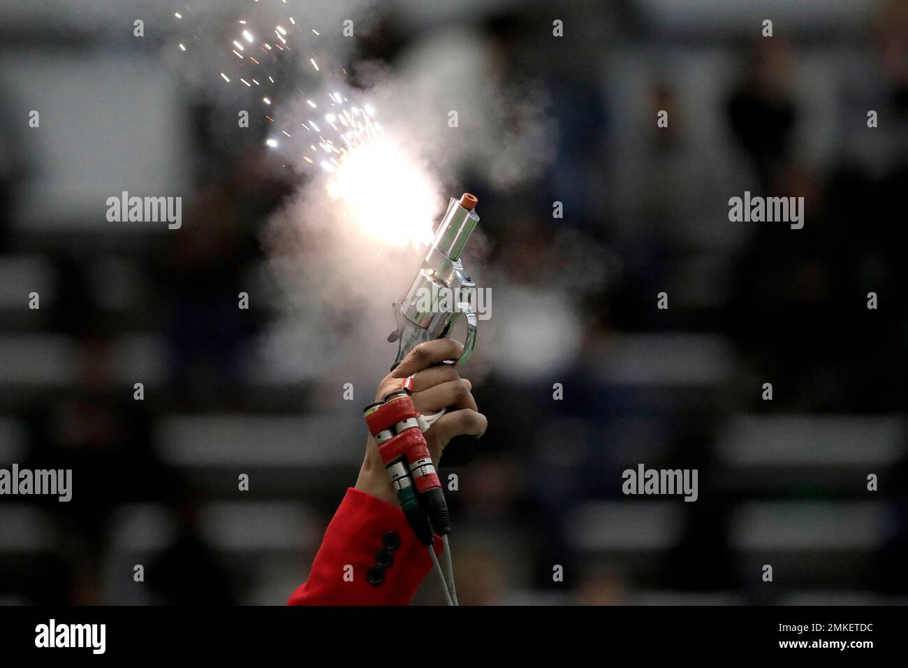 An official's starter pistol sets off a men's 1,000 meters heat at the ...