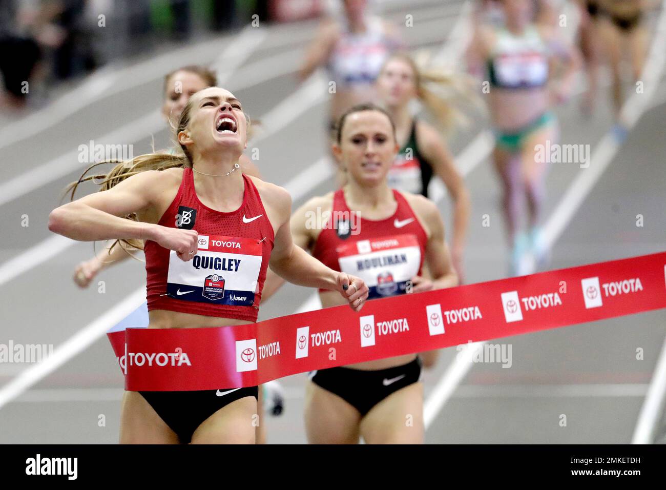 Colleen Quigley reacts as she breaks the tape to win the women's mile ...