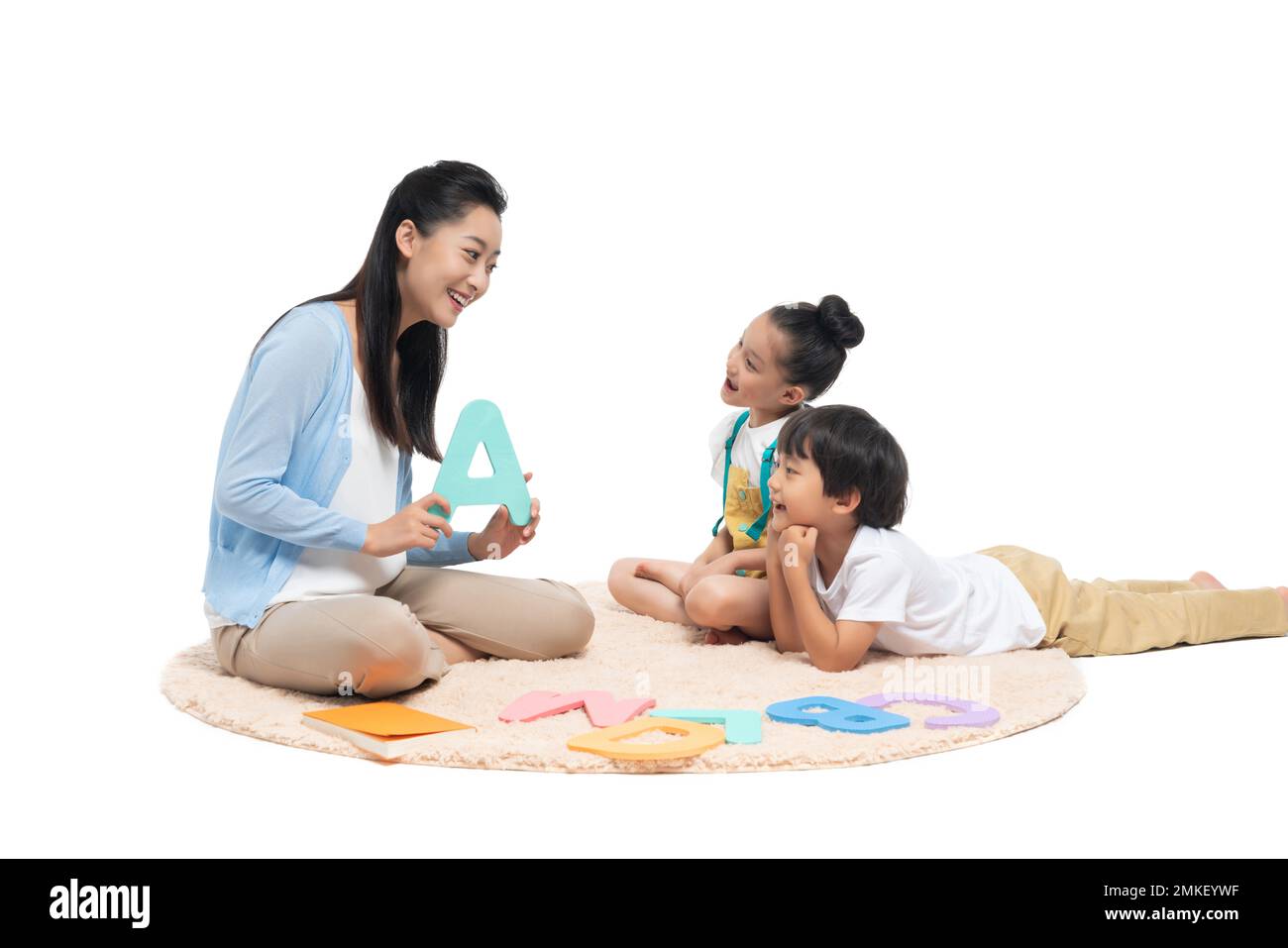 A young female teacher counseling students learning Stock Photo - Alamy