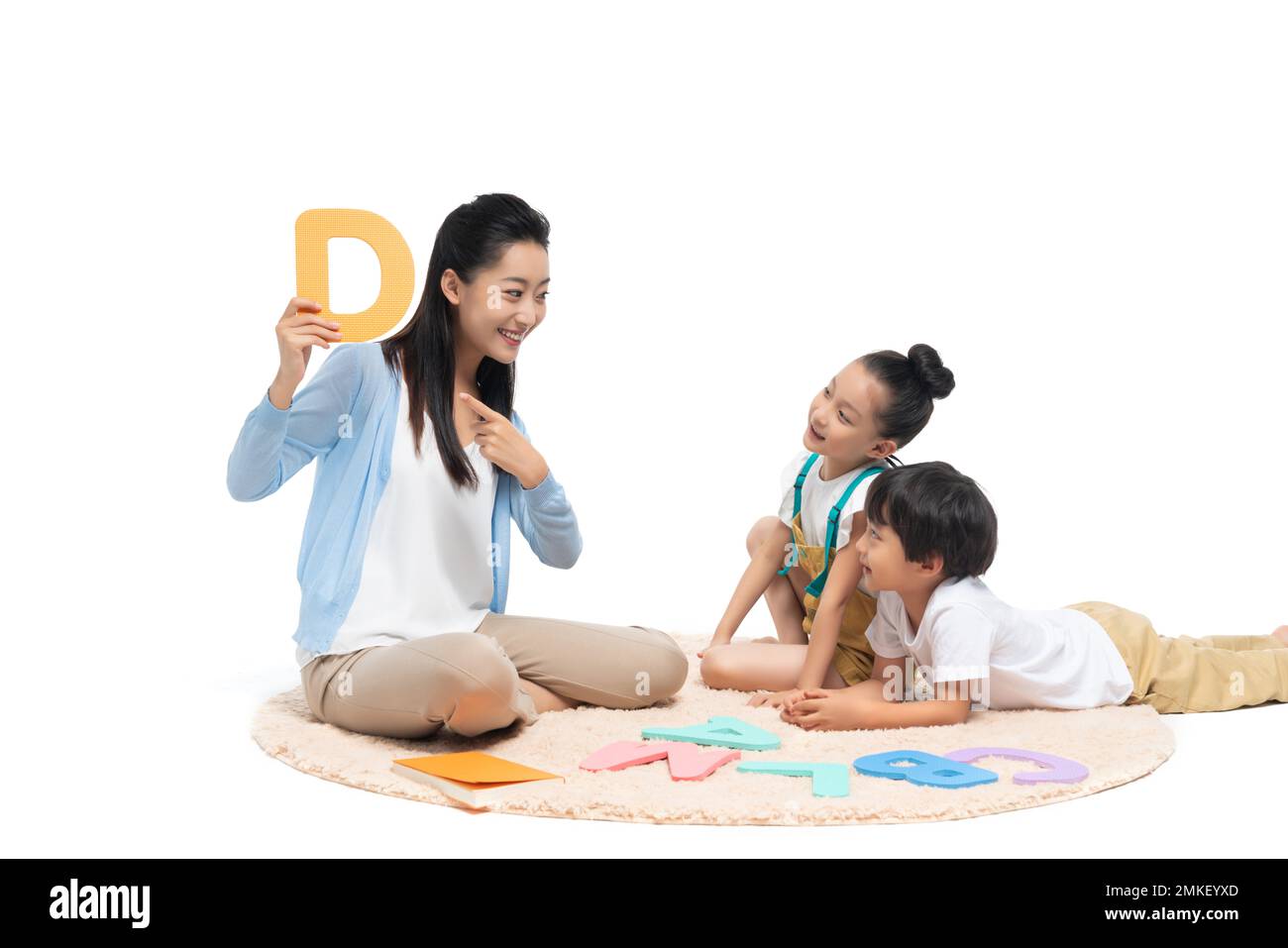 A young female teacher counseling students learning Stock Photo - Alamy