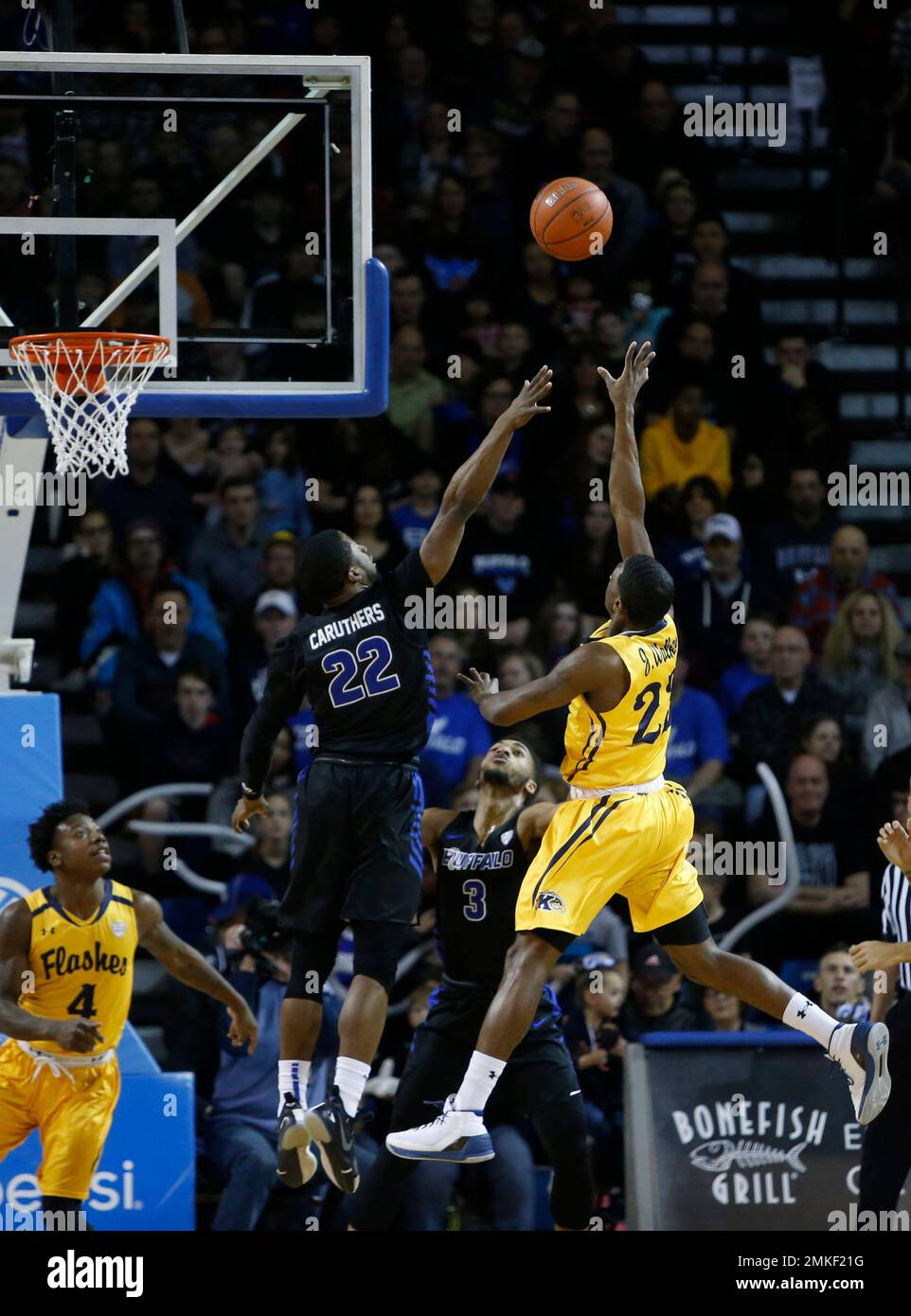 Buffalo guard Dontay Caruthers (22) goes up to block Kent State guard ...