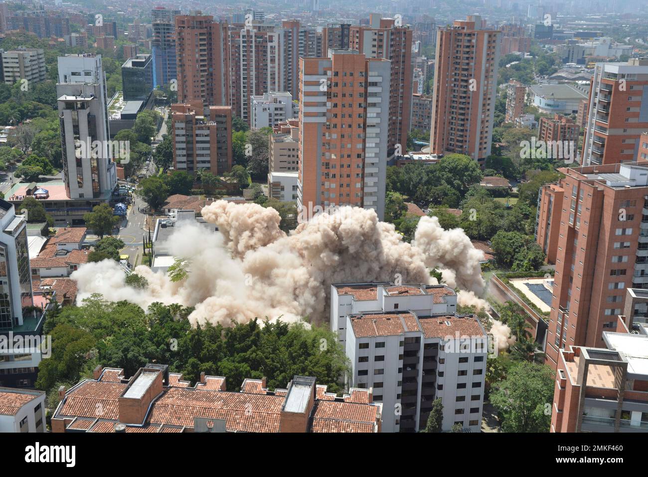 Clouds of dust rise during the implosion of a six-floor apartment ...