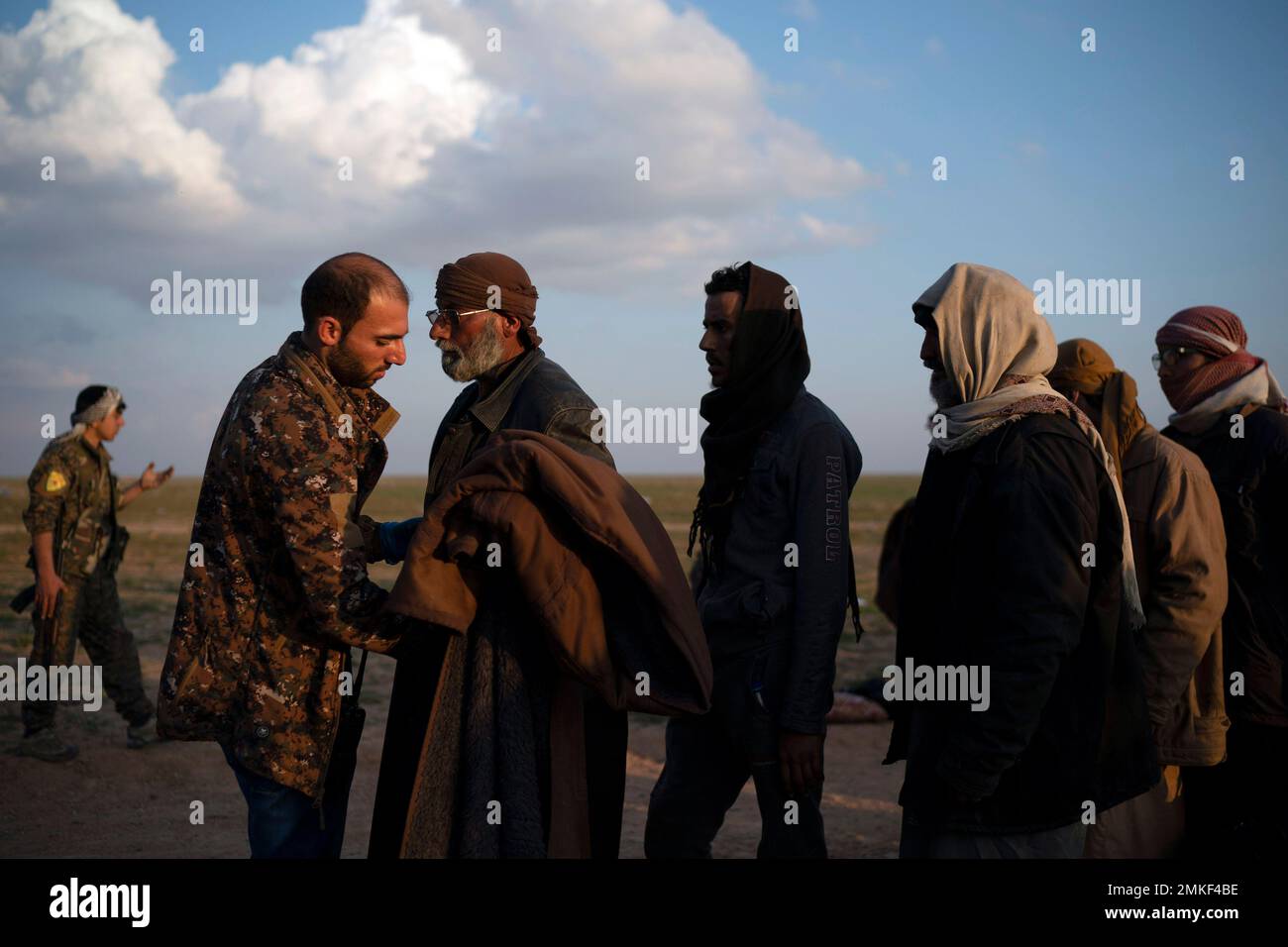 A man is frisked by a U.S.-backed Syrian Democratic Forces (SDF ...
