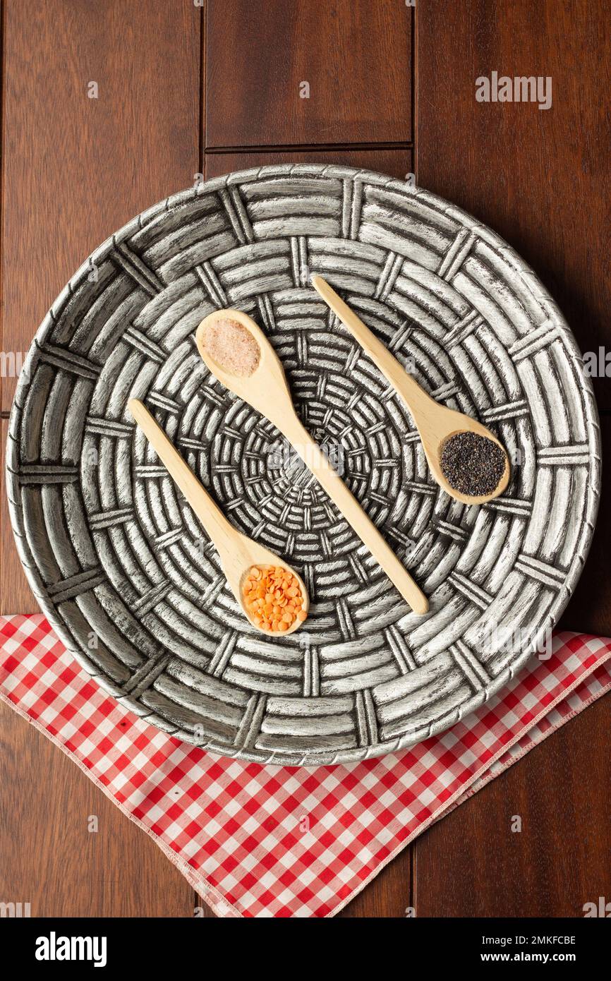 poppy seeds, pink lentils and pink himalayan salt in spoons and ...