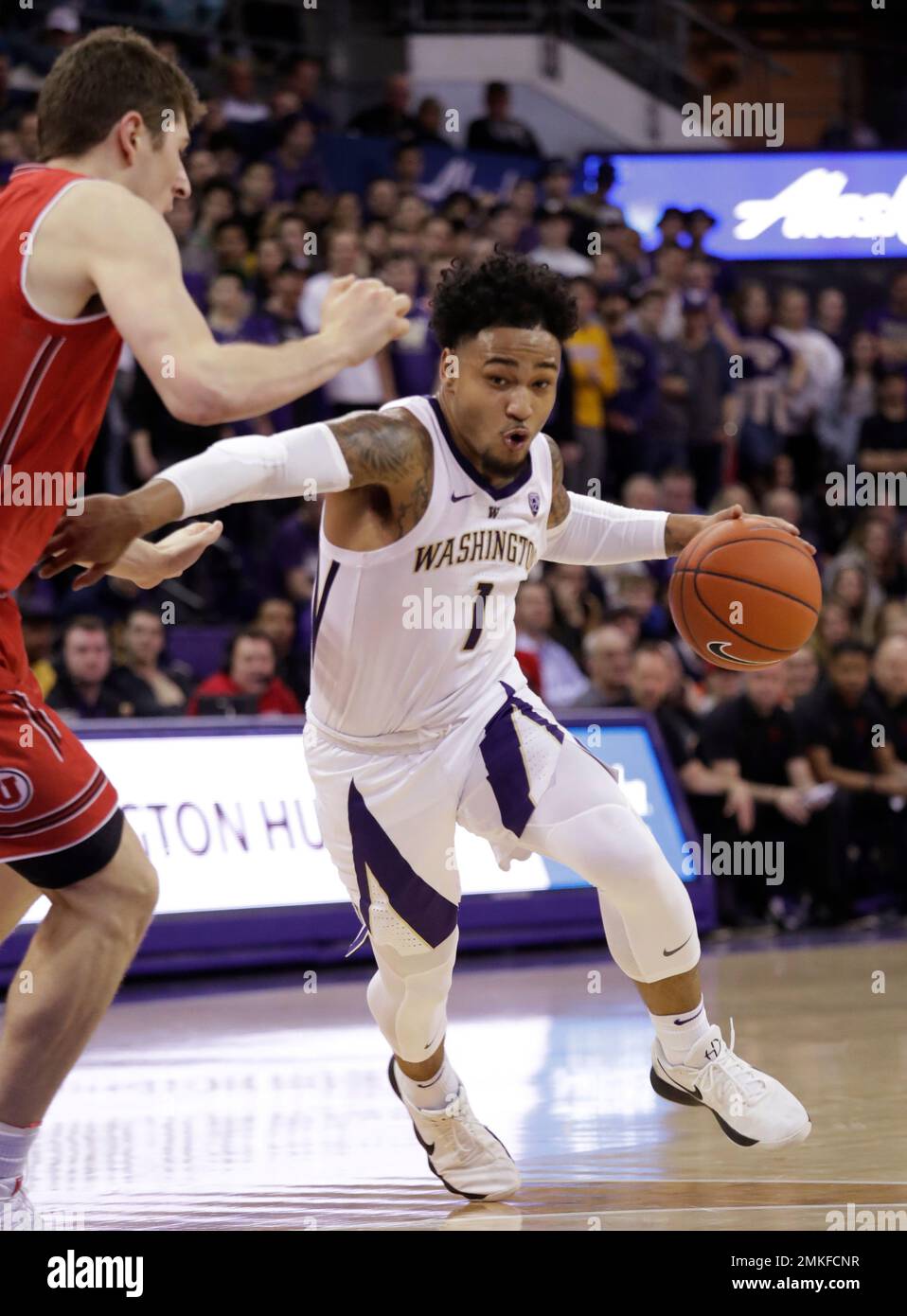 Washington's David Crisp drives against a Utah defender during the ...