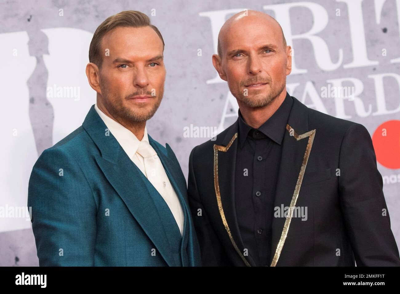 Musicians Matt Goss, left, and Luke Goss pose for photographers upon arrival at the Brit Awards ...