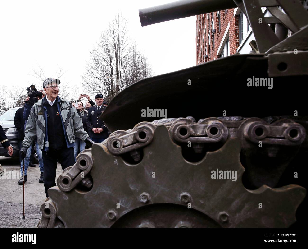 World War II tank gunner Clarence Smoyer admires a tank near the ...