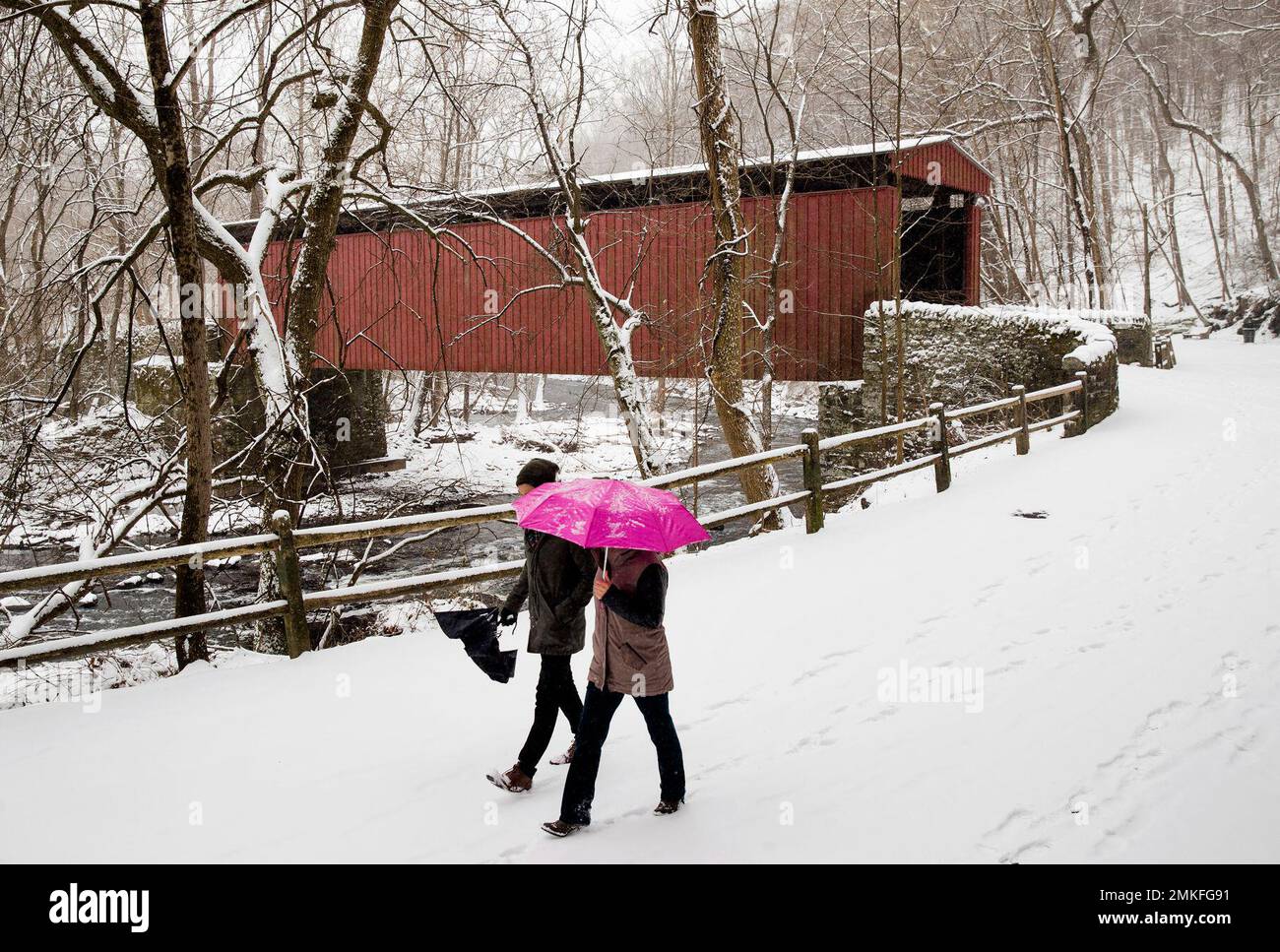 Hikers walk from the Thomas Mill Covered Bridge at Fairmount Park as ...