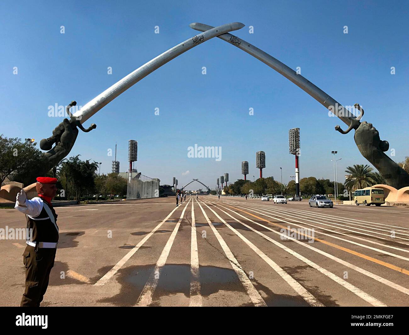 Security forces stand guard by the crossed swords monument in Baghdad ...