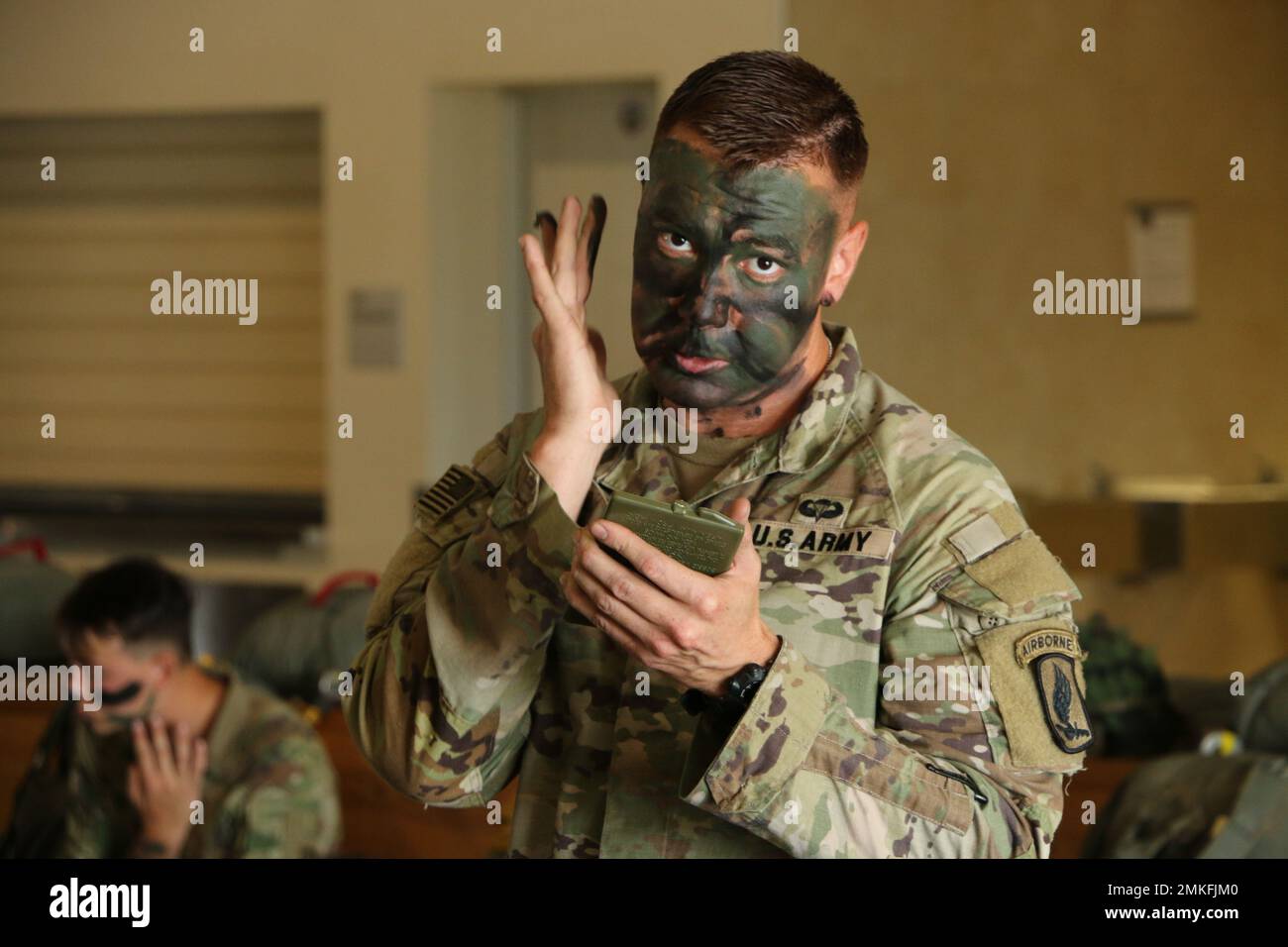 Spc. Steven Suarez of the 173rd Airborne Brigade applies camouflage ...
