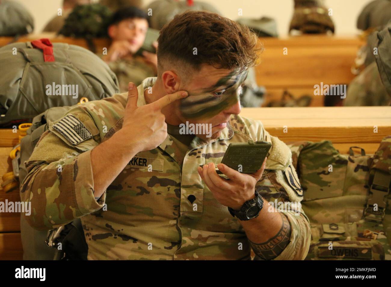 Spc. Addison Parker applies the finishing touches to his face camo for ...