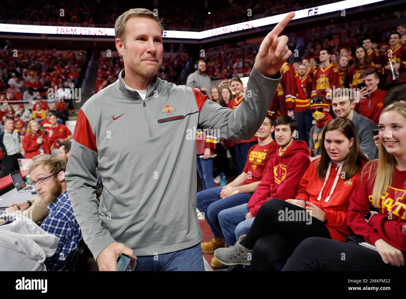 Former Iowa State head coach Fred Hoiberg points to fans as he walks by ...
