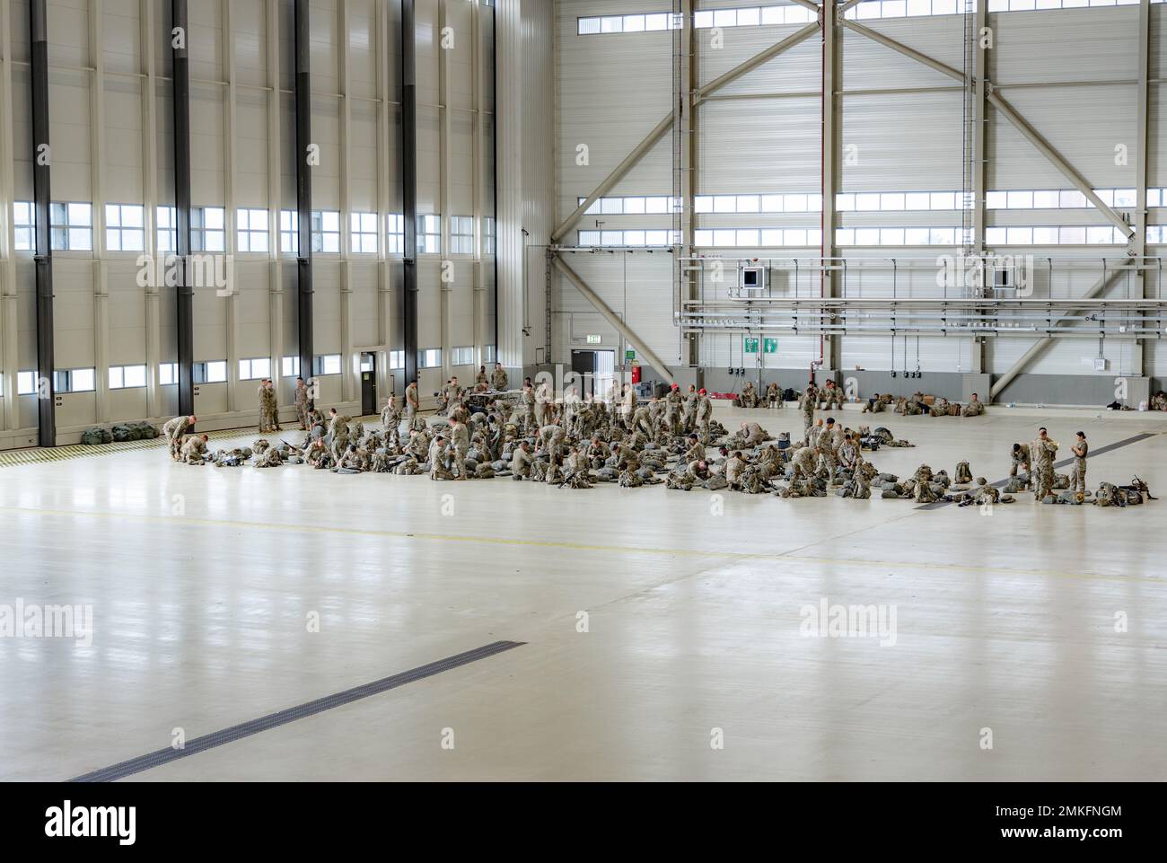 U.S. Army soldiers assigned to the 173rd Airborne Brigade wait to load ...