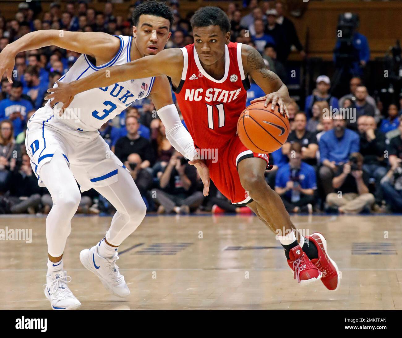 North Carolina State's Markell Johnson (11) drives against Duke's Tre ...