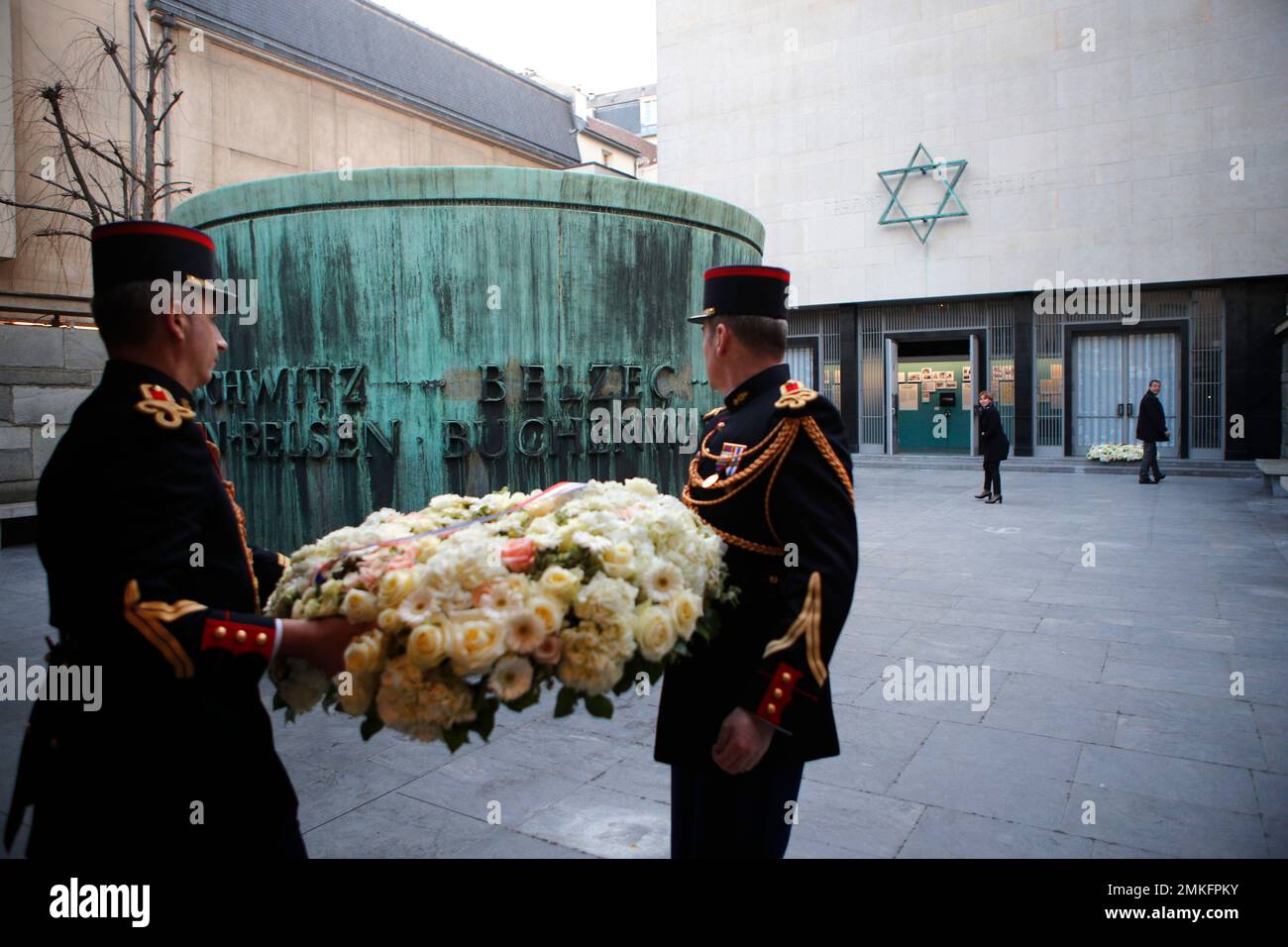 Republican Guards carry a wreath of flowers at the Shoah memorial ...