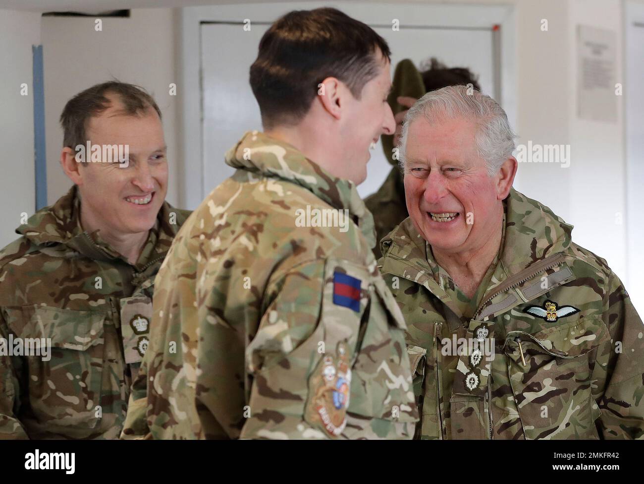Britain's Prince of Wales, Colonel, Welsh Guards, right, laughs as he ...