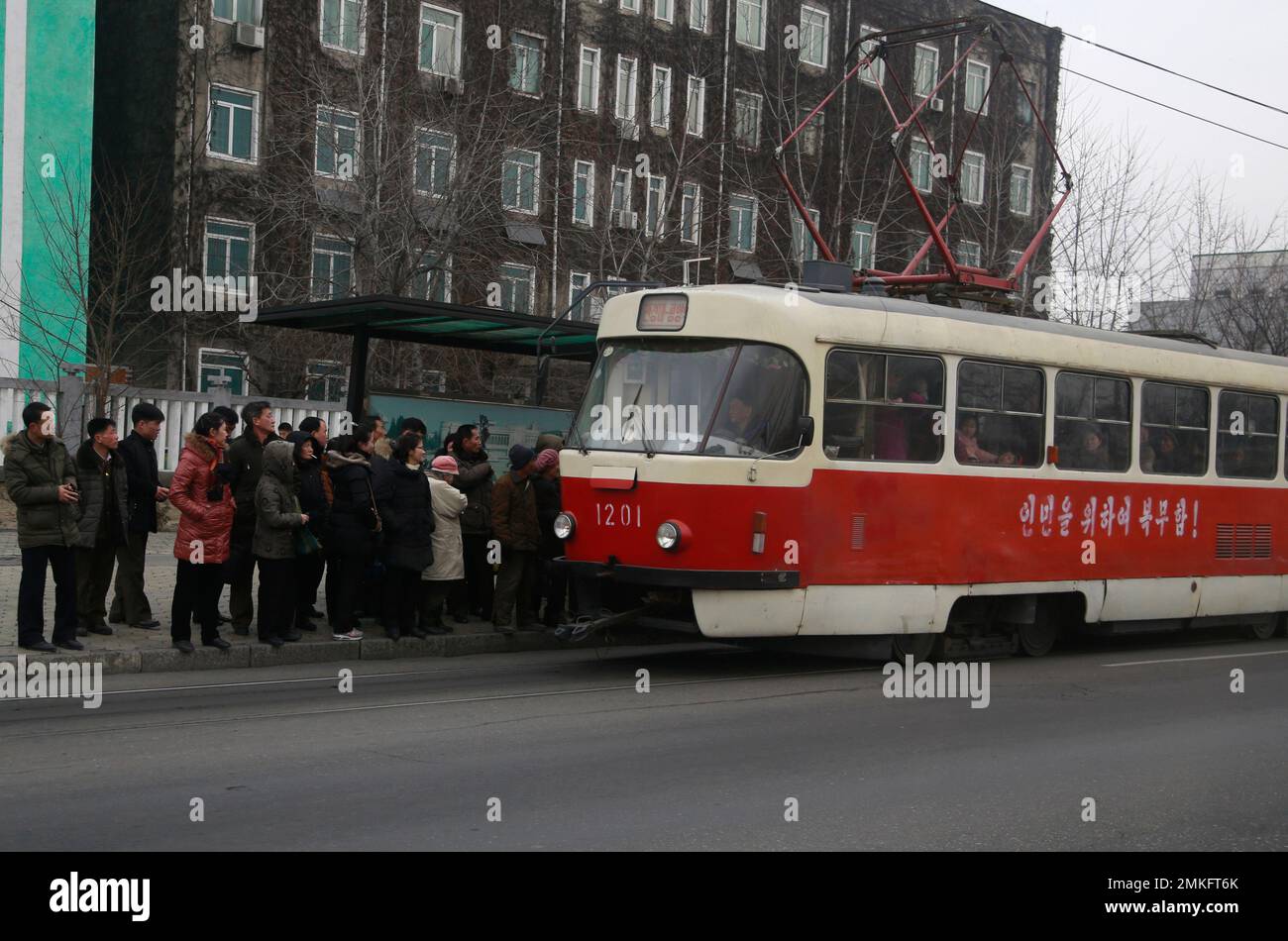 In this Saturday, Feb. 2, 2019 photo, people queue up to board a tram ...