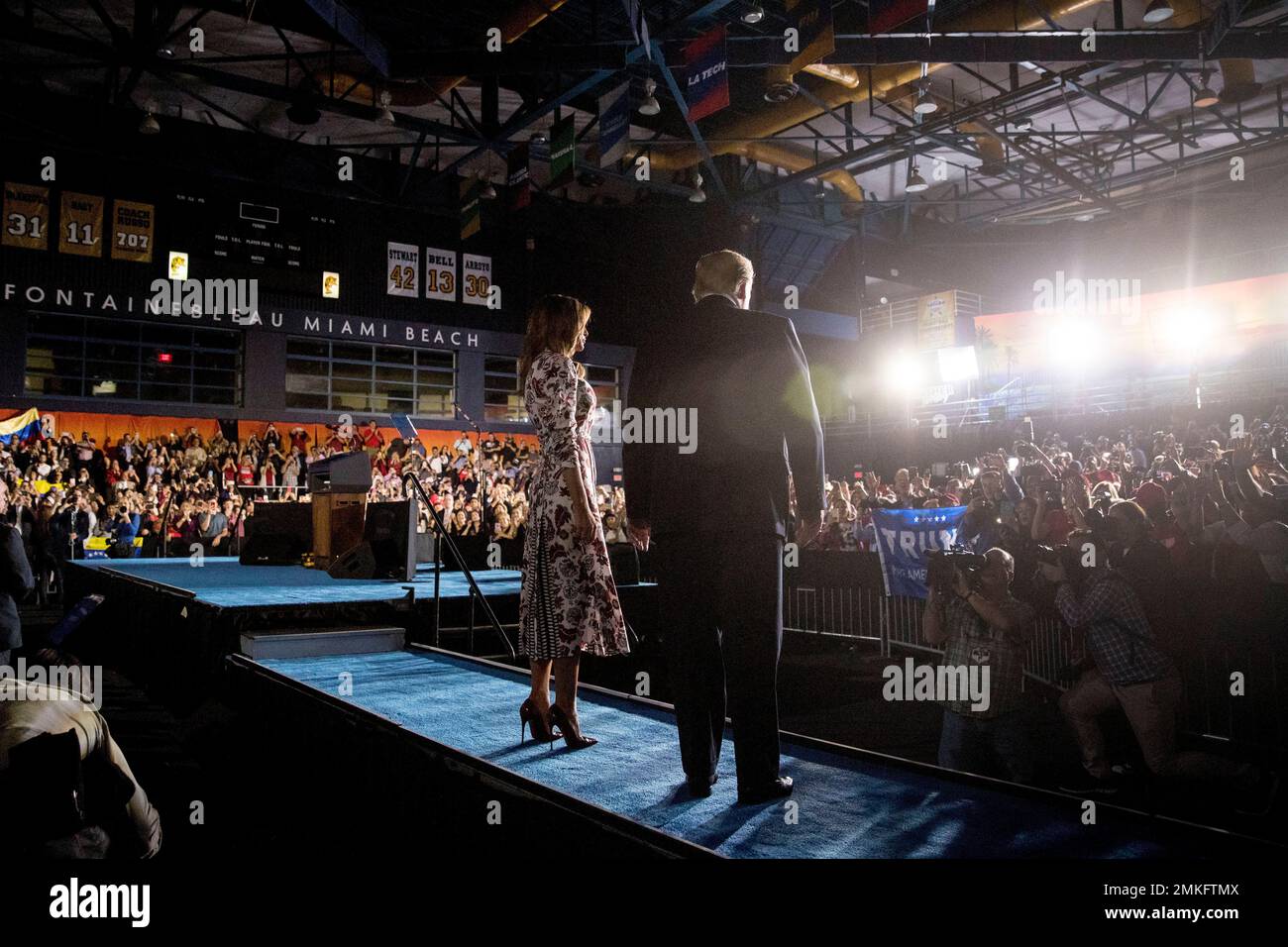 President Donald Trump and first lady Melania Trump take the stage in ...