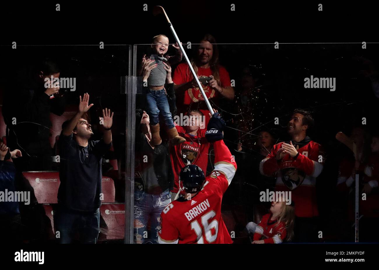 Florida Panthers center Aleksander Barkov gives a child a hockey stick ...