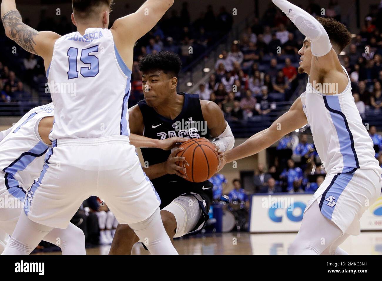 Gonzaga forward Rui Hachimura, center, drives between San Diego forward ...