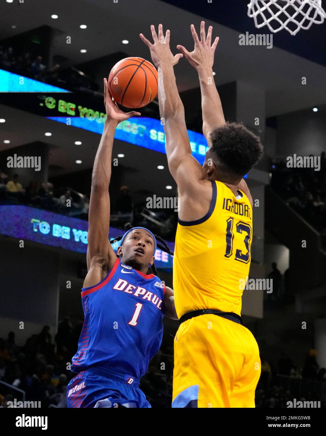 DePaul's Javan Johnson (1) shoots as Marquette's Oso Ighodaro defends ...