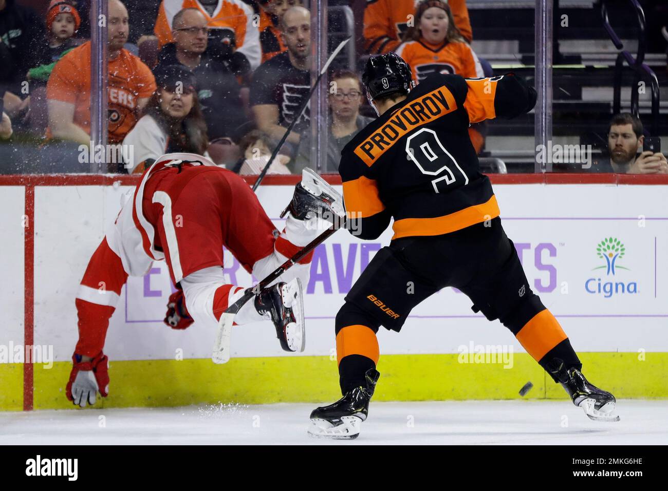 Detroit Red Wings' Justin Abdelkader, left, goes flying after trying to ...