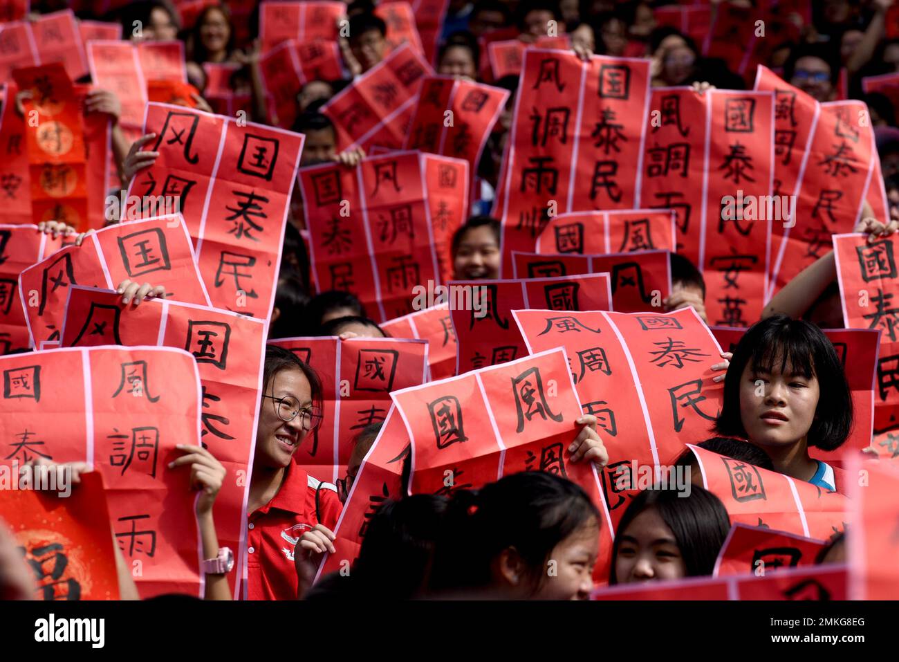 Malaysia's ethnic Chinese students pose with their artwork during a ...