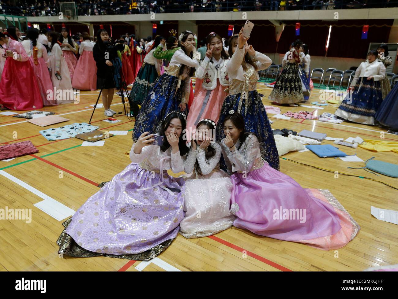 South Korean seniors clad in traditional attire take a souvenir photo ...