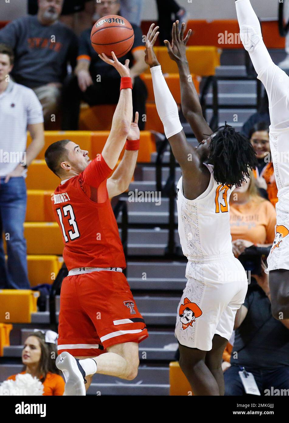 Texas Tech guard Matt Mooney (13) shoots as Oklahoma State guard Isaac ...