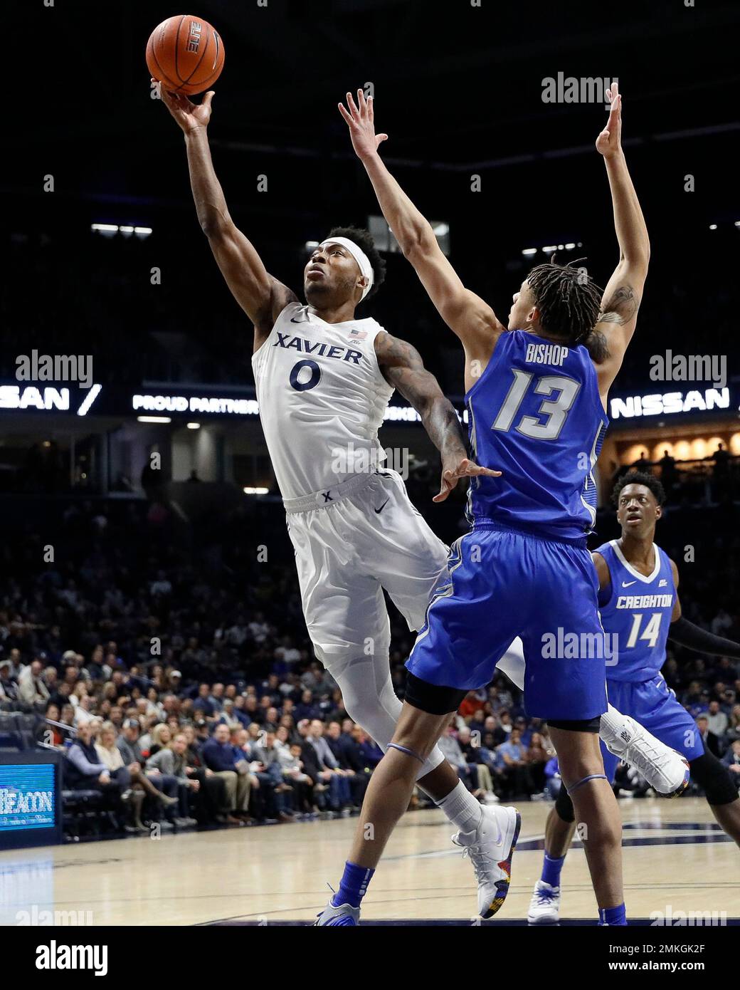 Xavier's Tyrique Jones (0) shoots next to Creighton's Christian Bishop ...