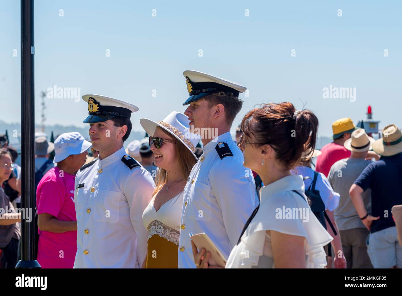 Australian Naval officers pose for a photograph with a woman during ...