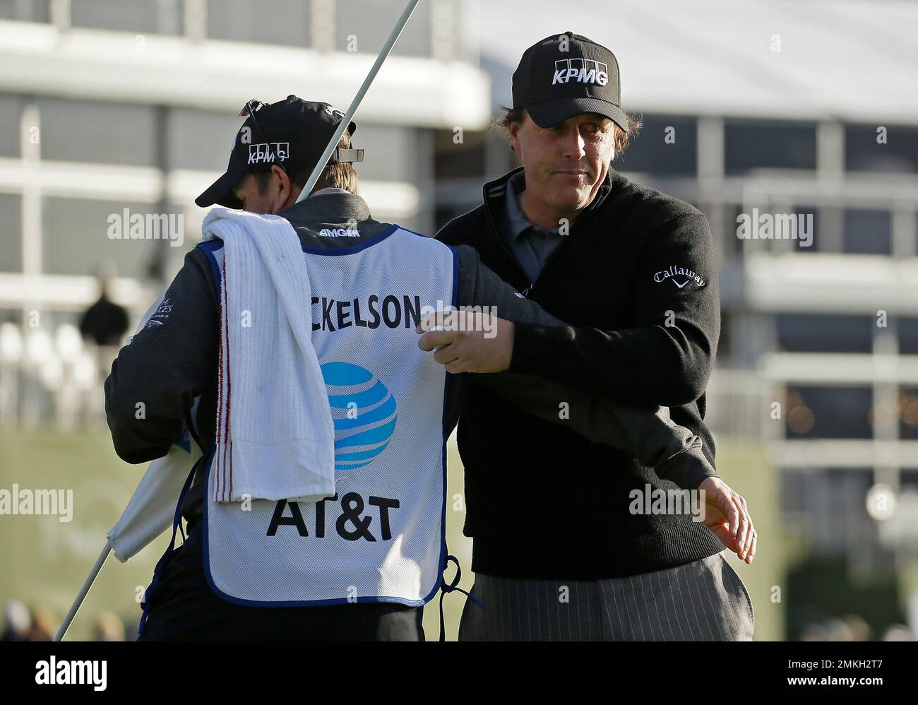 Phil Mickelson is embraced by his caddie and brother Tim Mickelson on ...